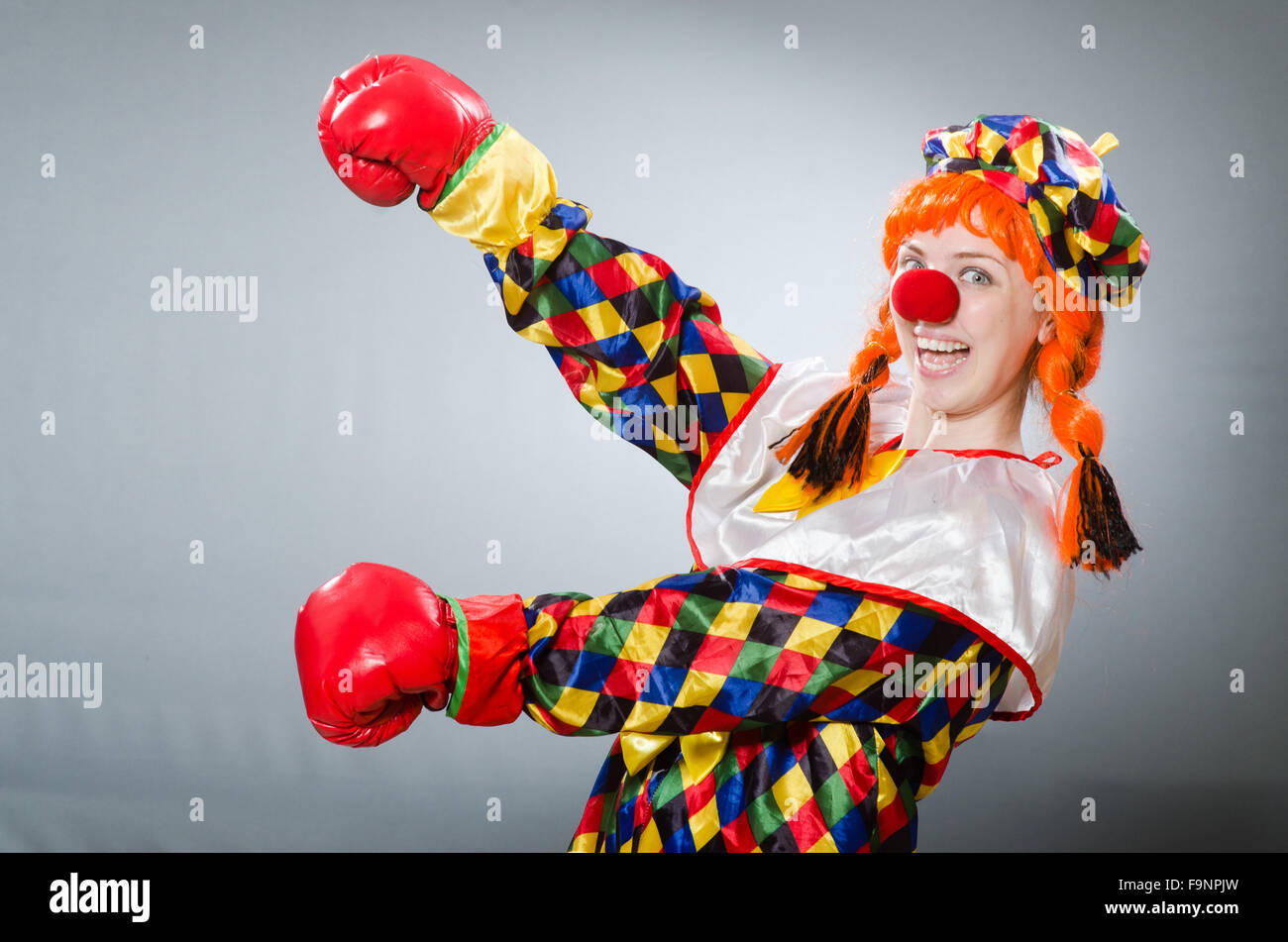 Clown with boxing gloves isolated on white Stock Photo - Alamy
