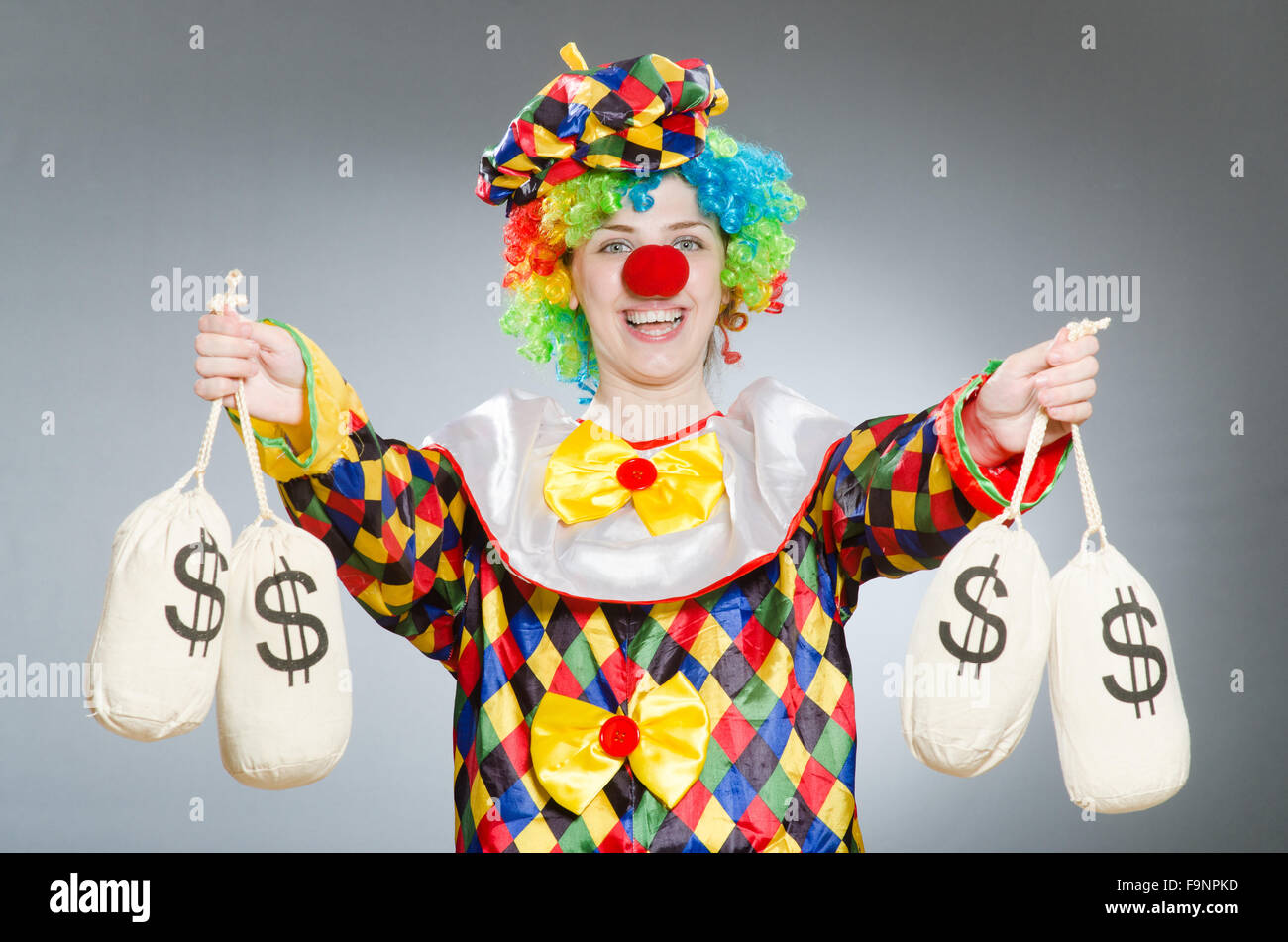 Clown with money bag in funny concept Stock Photo - Alamy