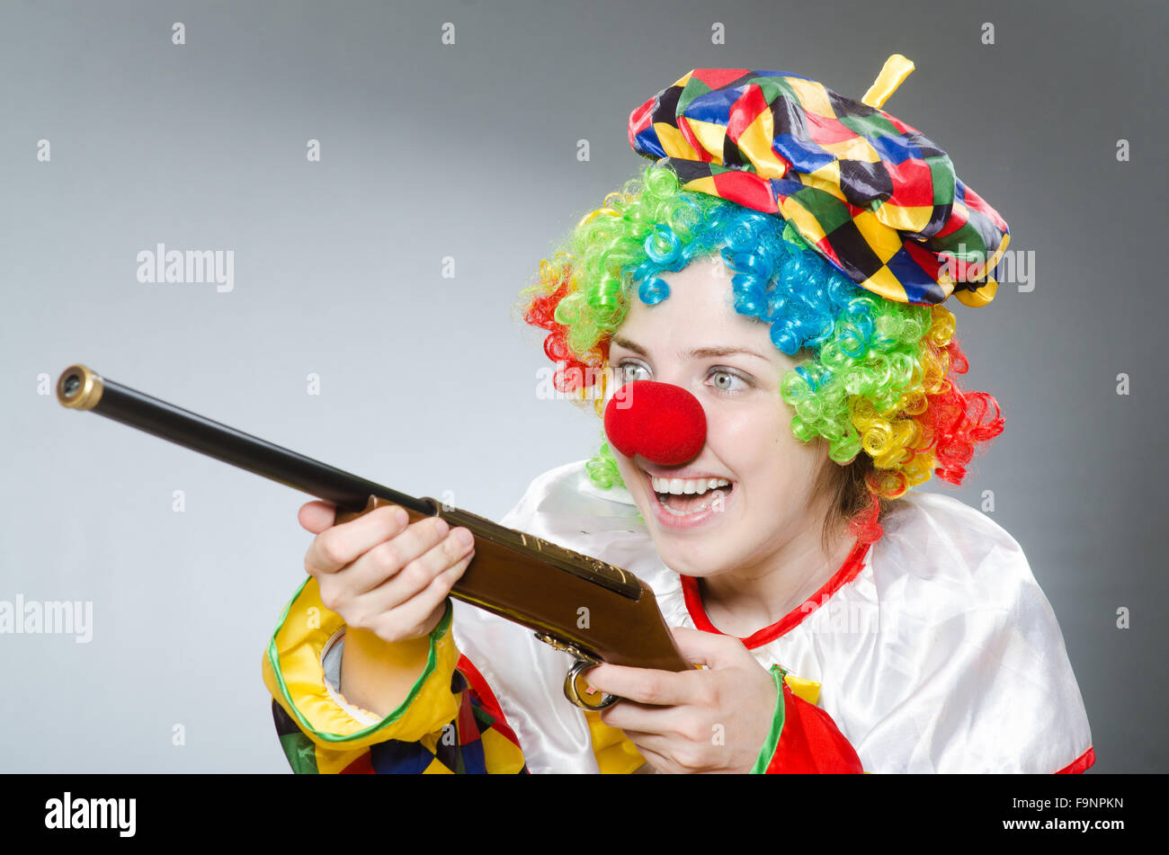 Clown with rifle isolated on white Stock Photo - Alamy