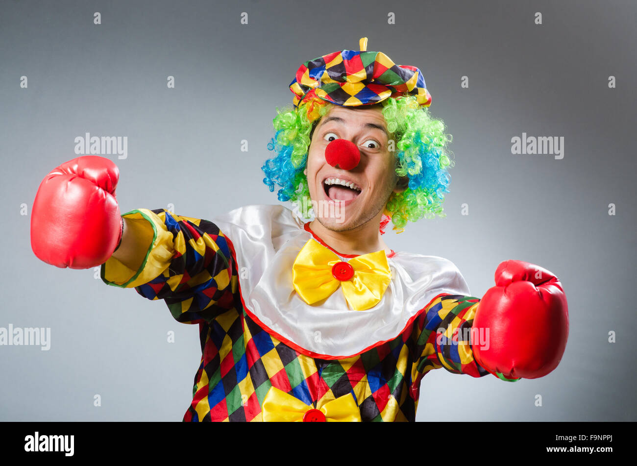Clown with boxing gloves isolated on white Stock Photo - Alamy