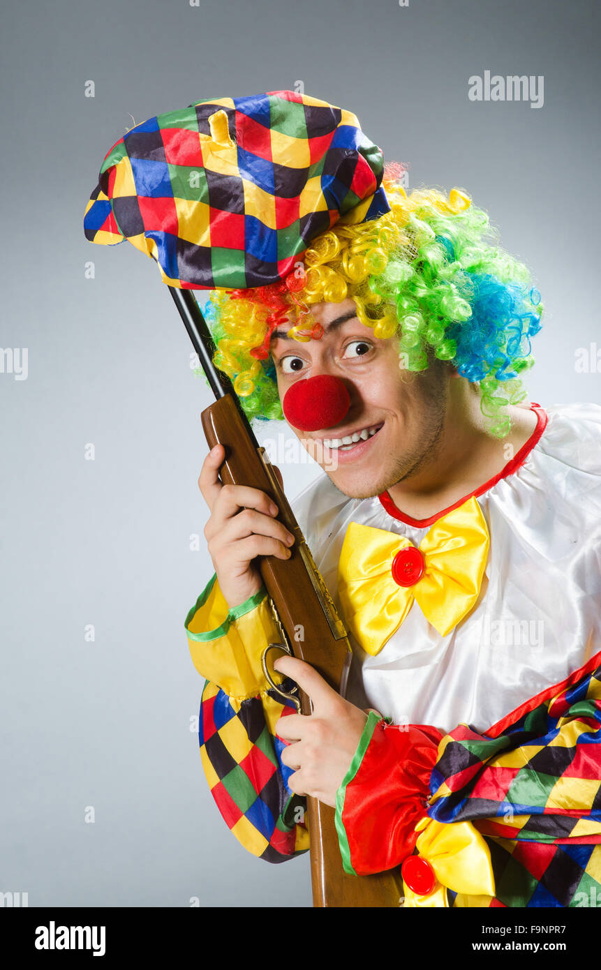 Clown with rifle isolated on white Stock Photo - Alamy