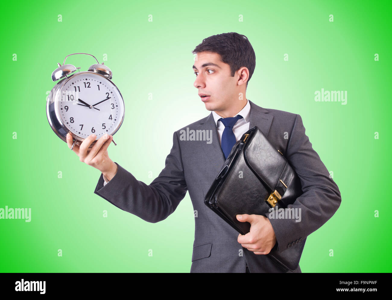 Businessman with clock isolated on white Stock Photo - Alamy