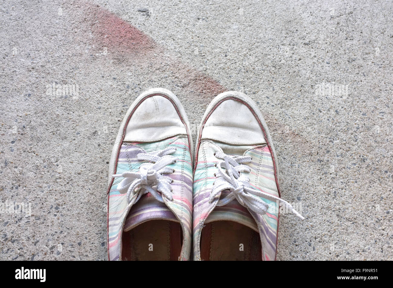 Colourful sneakers on cement floor Stock Photo - Alamy
