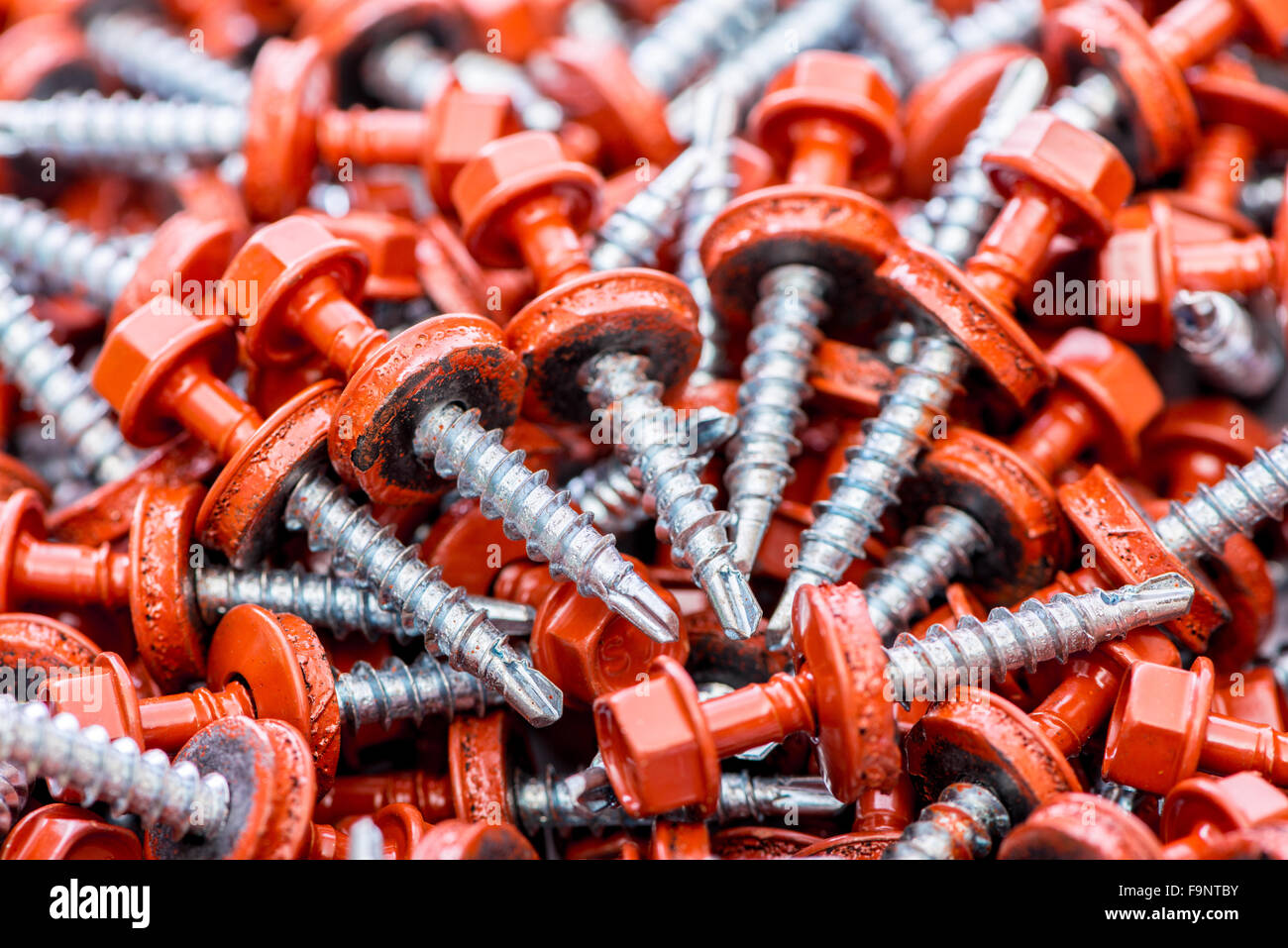 Many screws arranged as background Stock Photo - Alamy