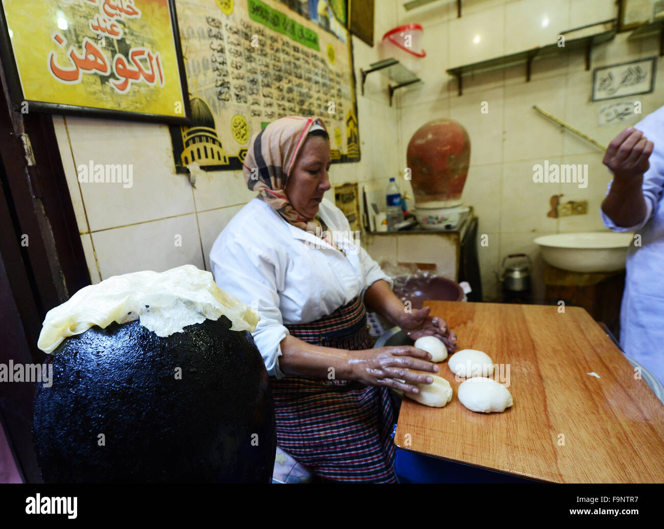 A Moroccan woman preparing a traditional thin crep called Tride Stock ...