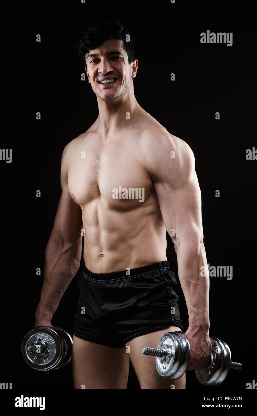 Muscular ripped bodybuilder with dumbbells Stock Photo - Alamy