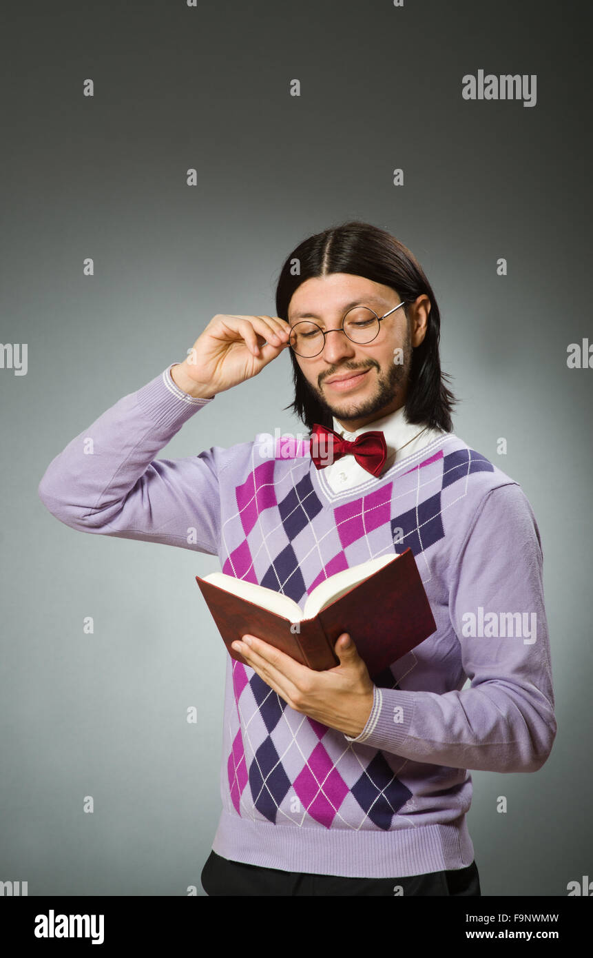Young student with book in learning concept Stock Photo - Alamy