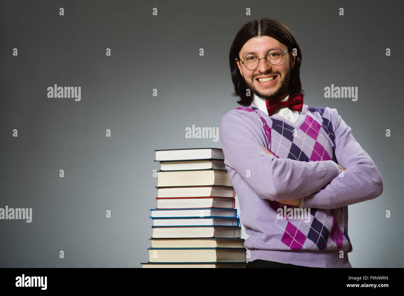 Young student with book in learning concept Stock Photo - Alamy