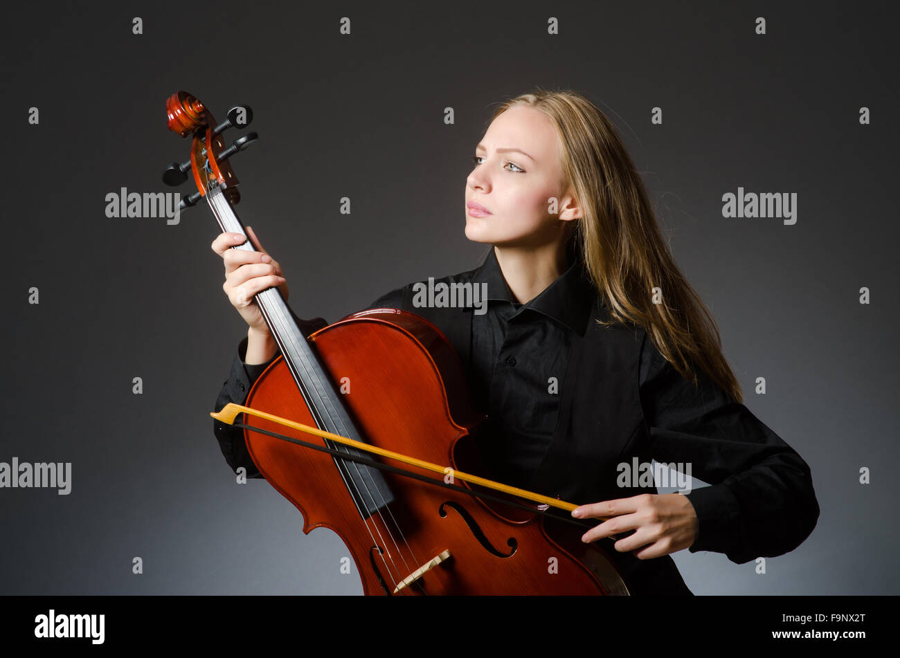 Woman playing classical cello in music concept Stock Photo - Alamy