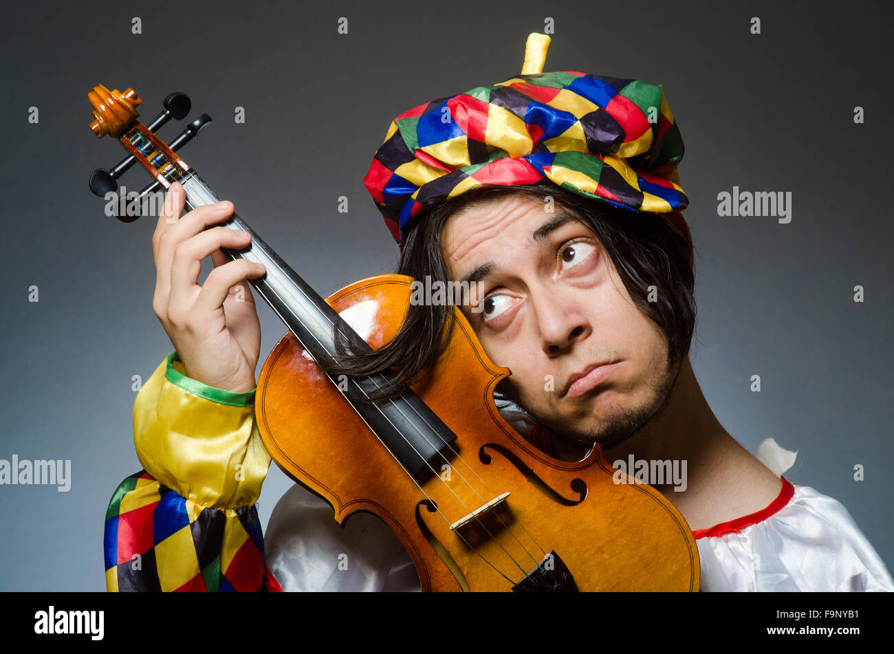 Funny violin clown player in musical concept Stock Photo - Alamy