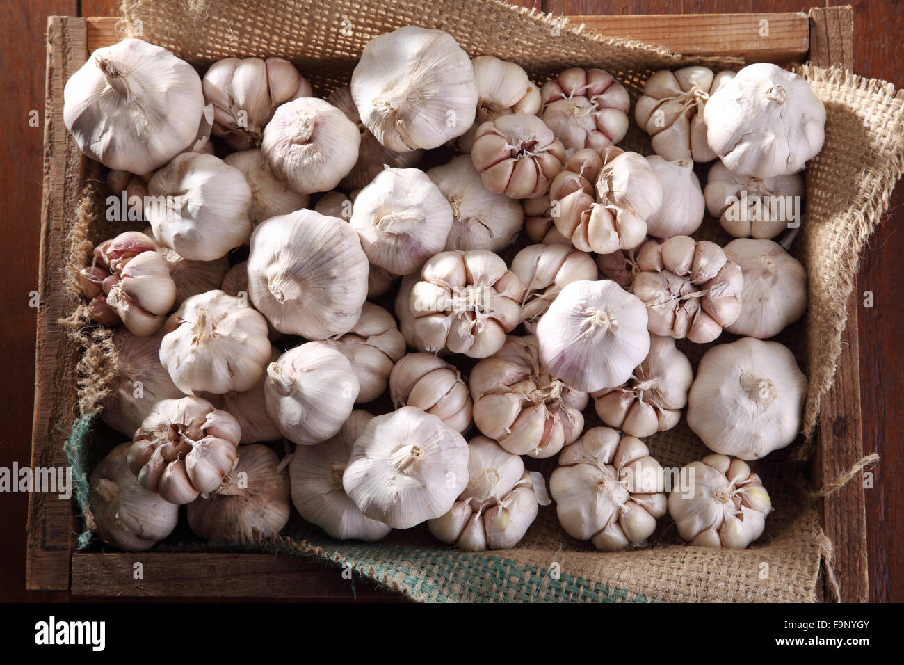 garlic in the wooden crate Stock Photo - Alamy