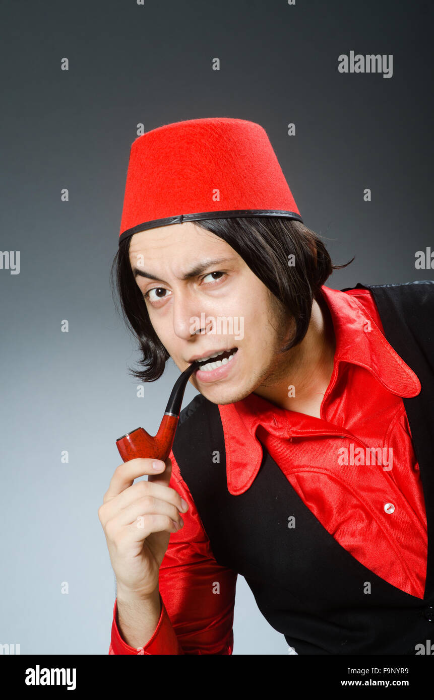 Man wearing fez hat smoking hi-res stock photography and images - Alamy