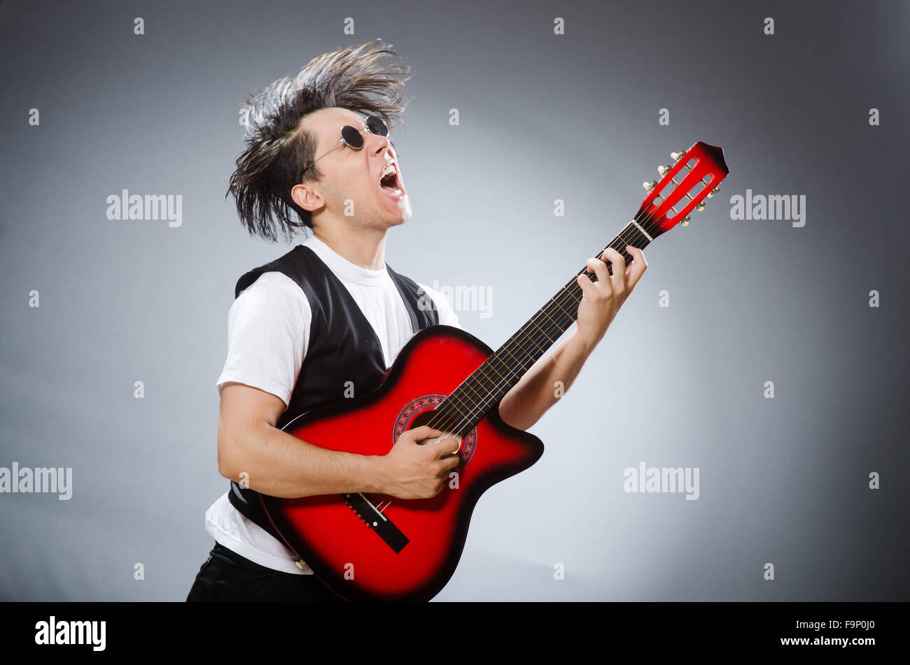 Funny guitar player in musical concept Stock Photo - Alamy