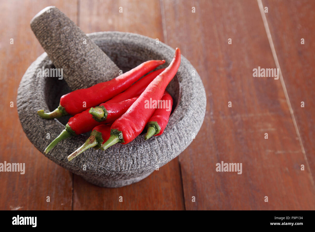 red chilli on mortar and pestle Stock Photo - Alamy