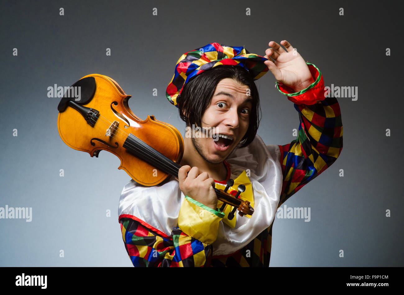 Funny violin clown player in musical concept Stock Photo - Alamy