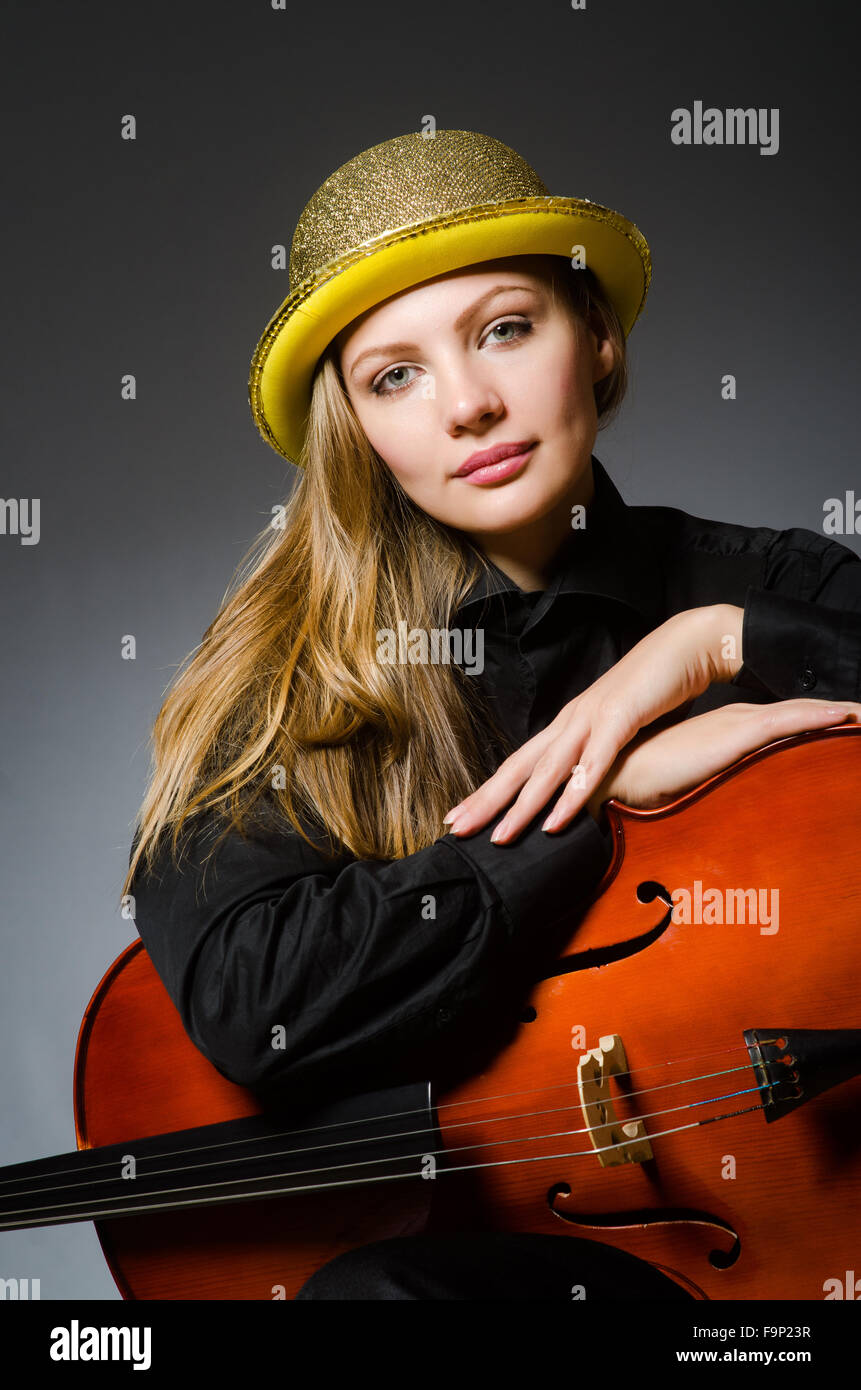 Woman playing classical cello in music concept Stock Photo - Alamy