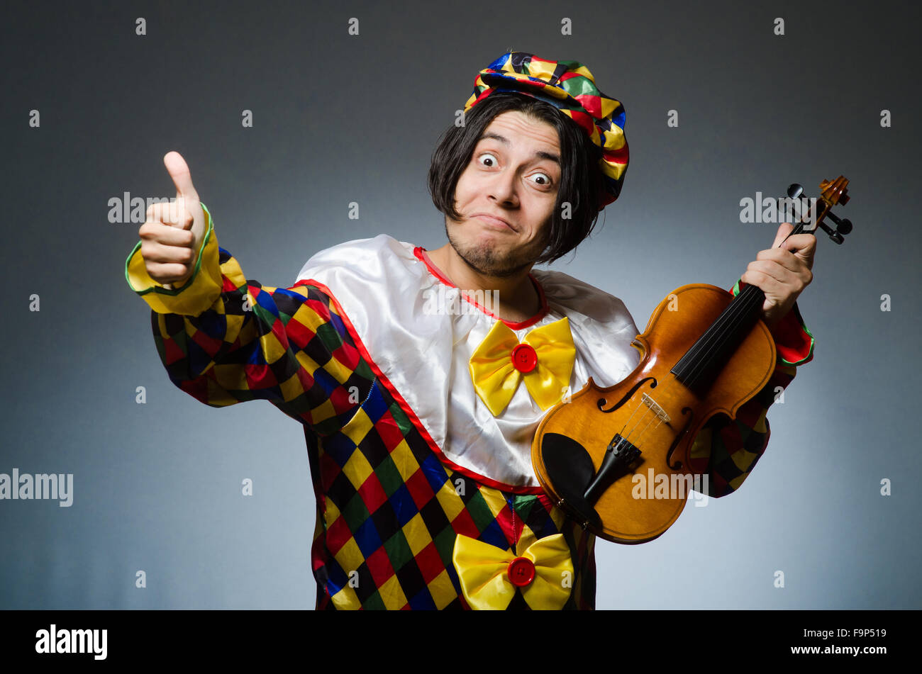 Funny violin clown player in musical concept Stock Photo - Alamy