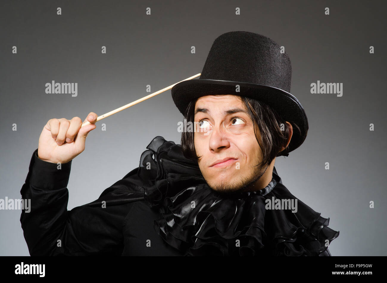 Funny magician wearing cylinder hat Stock Photo - Alamy