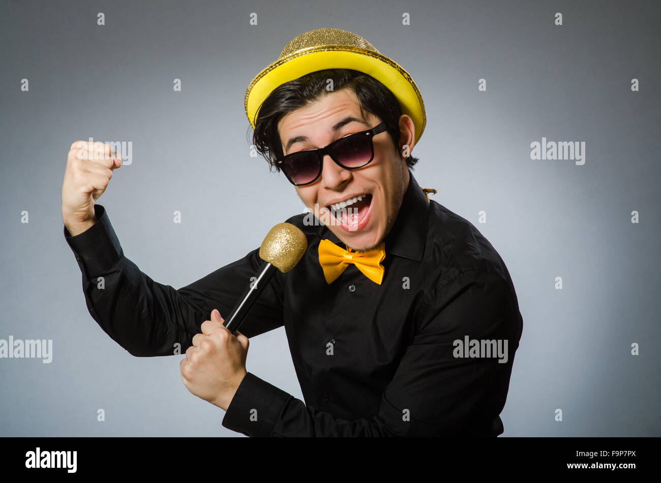 Funny man with mic in karaoke concept Stock Photo - Alamy