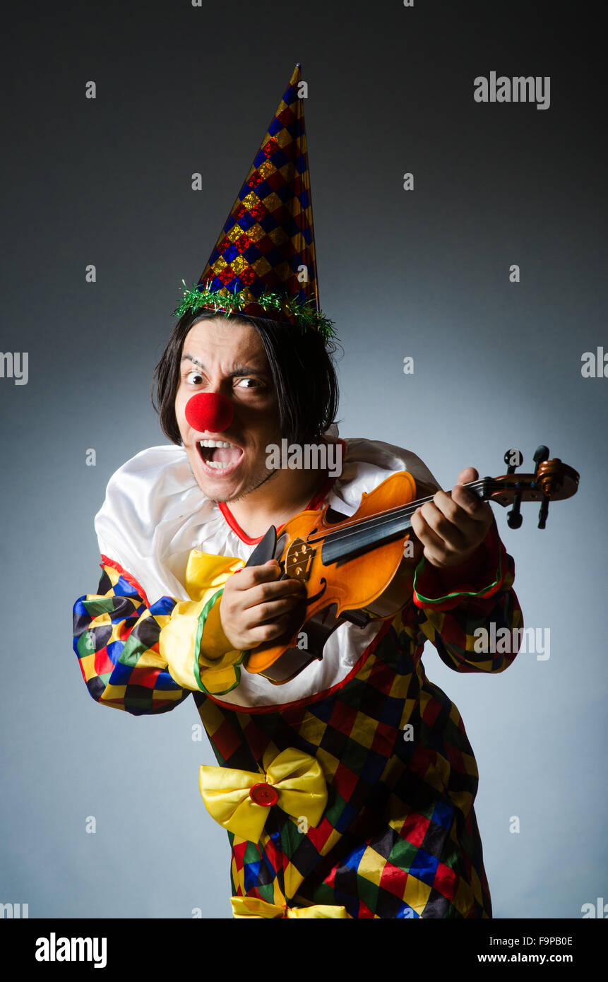 Funny violin clown player in musical concept Stock Photo - Alamy