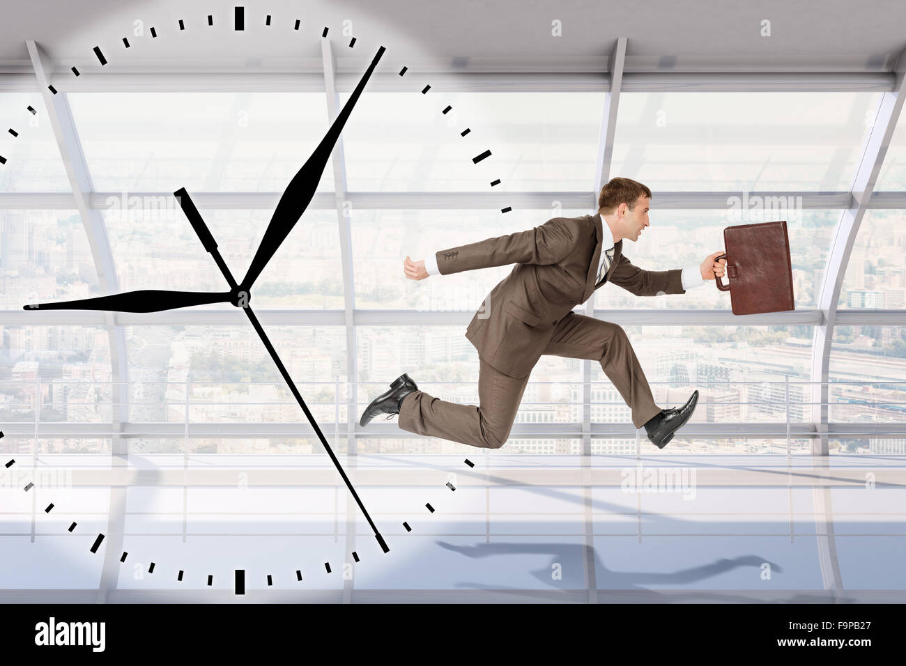 Businessman running with clock background Stock Photo - Alamy
