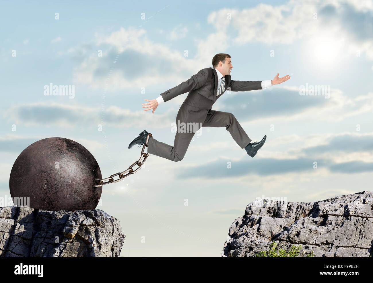 Image of young businessman jumping over gap Stock Photo - Alamy