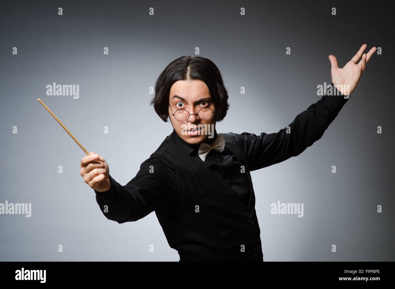 Funny conductor in musical concept Stock Photo - Alamy
