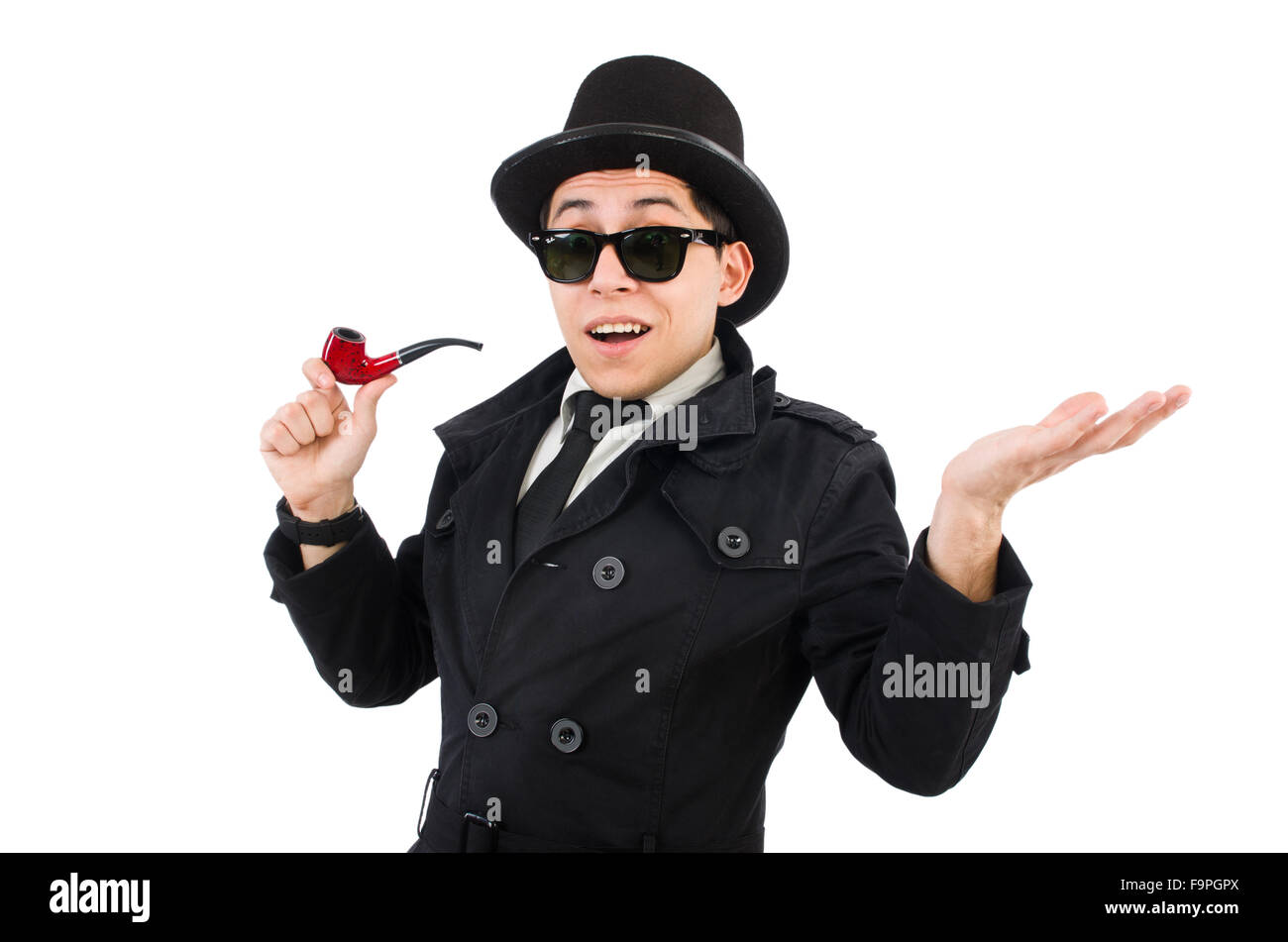 Young detective in black coat holding smoking pipe isolated on white ...