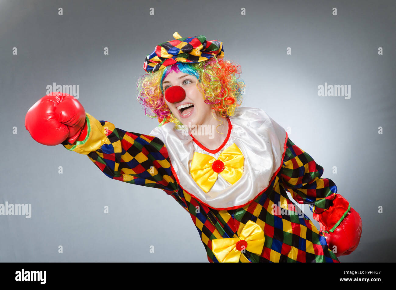 Clown with boxing gloves isolated on white Stock Photo - Alamy