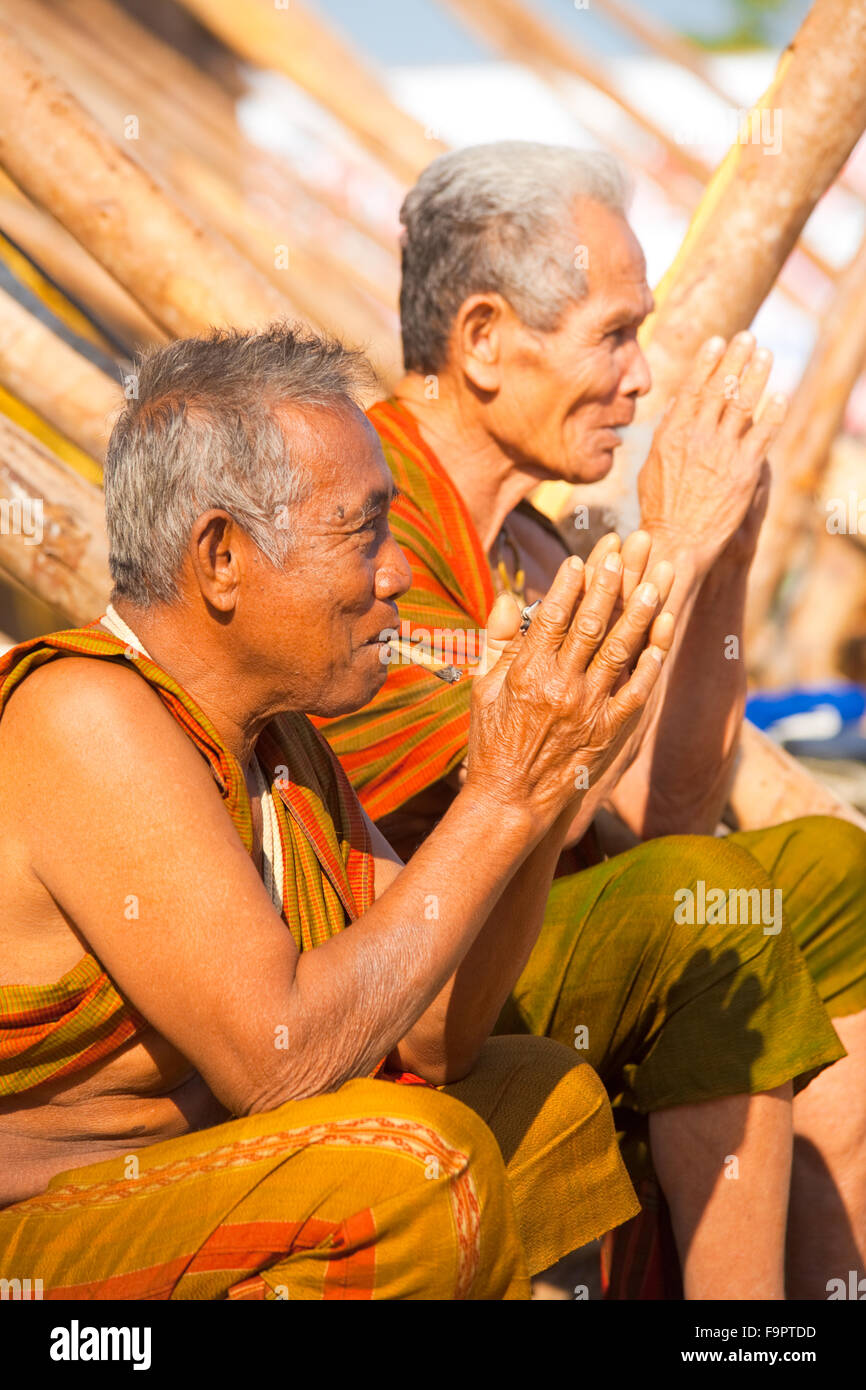Elder villagers sitting, smoking use a traditional hand gesture called ...