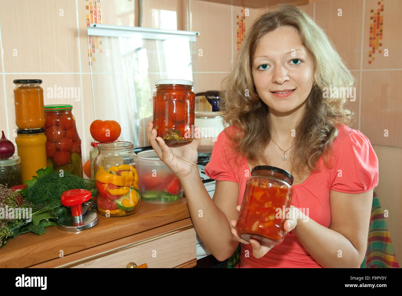 Woman with pickled vegetables in the kitchen Stock Photo - Alamy