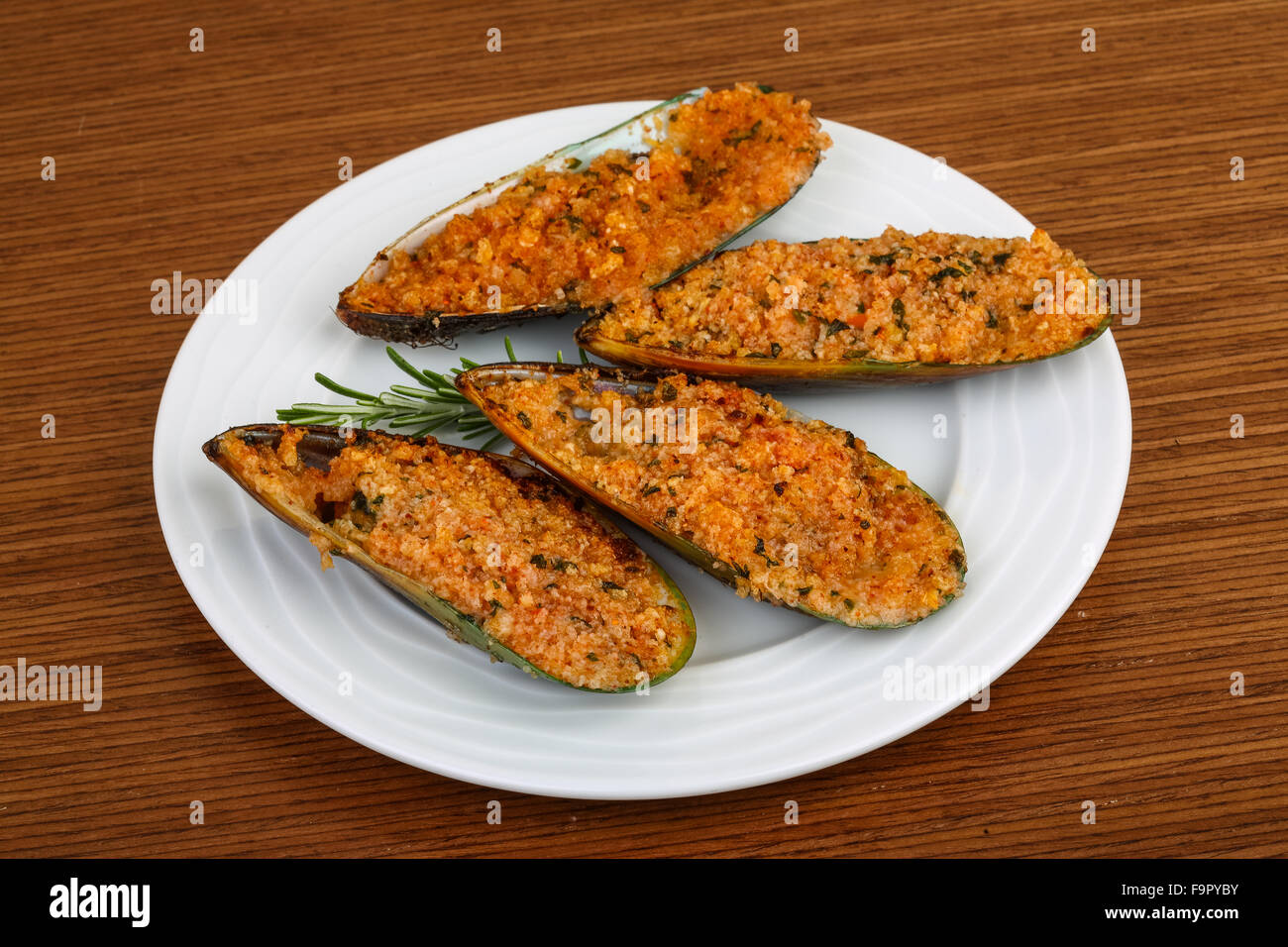 Baked mussels with bread and spices served rosemary Stock Photo - Alamy