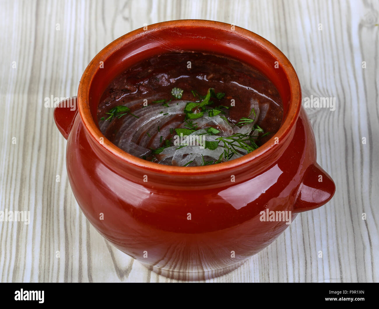 Georgian cuisine - Lobio with onion rings and fresh herbs Stock Photo ...