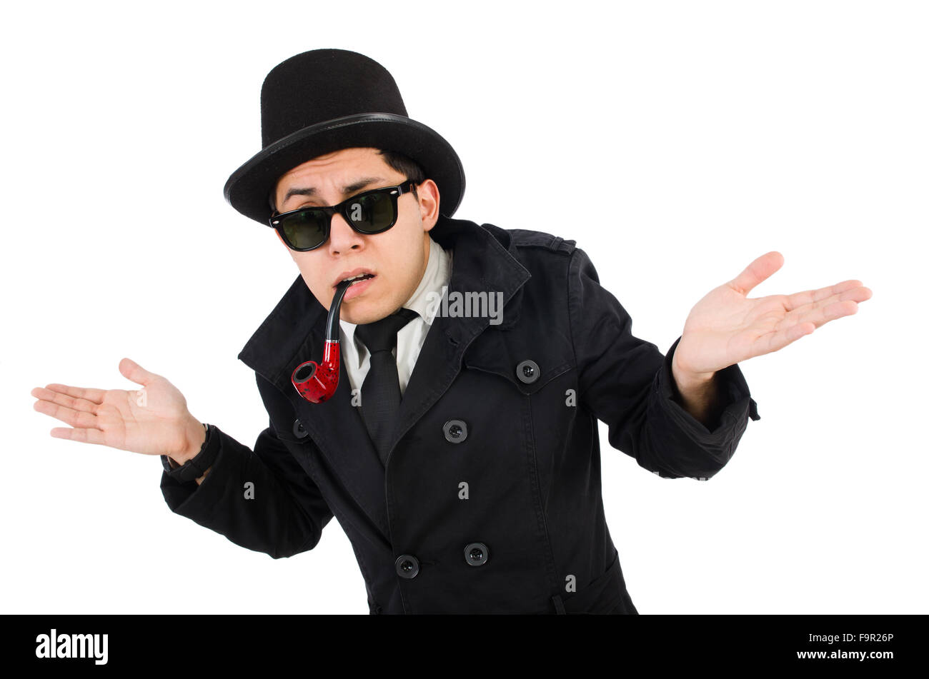 Young detective in black coat holding smoking pipe isolated on white ...