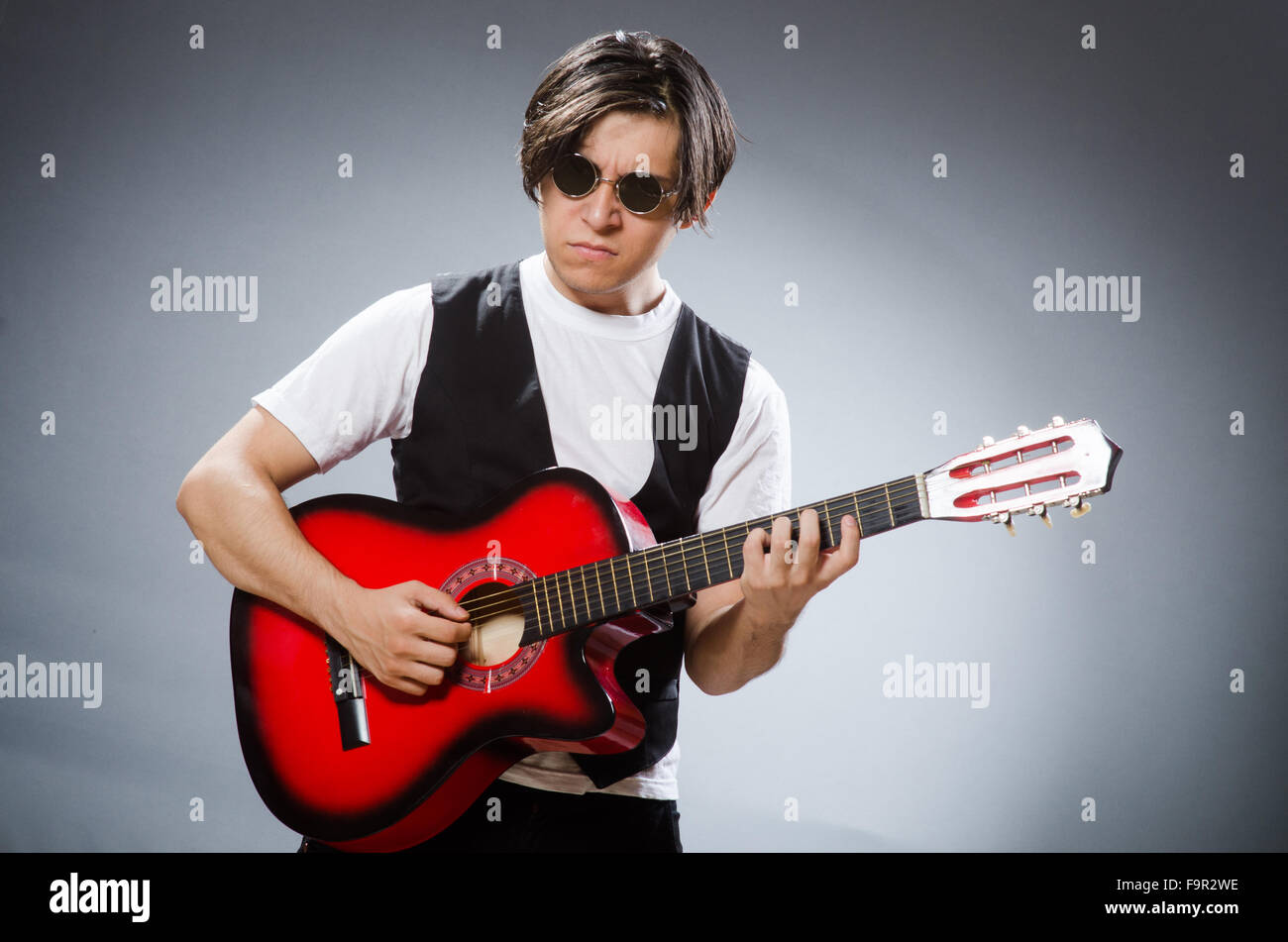 Funny guitar player in musical concept Stock Photo - Alamy