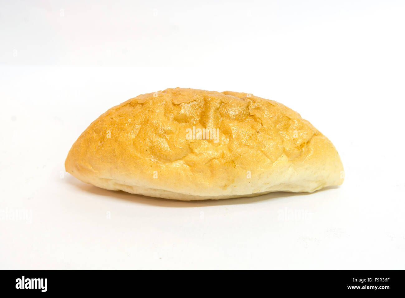 golden brown oval bread isolated on white background Stock Photo - Alamy