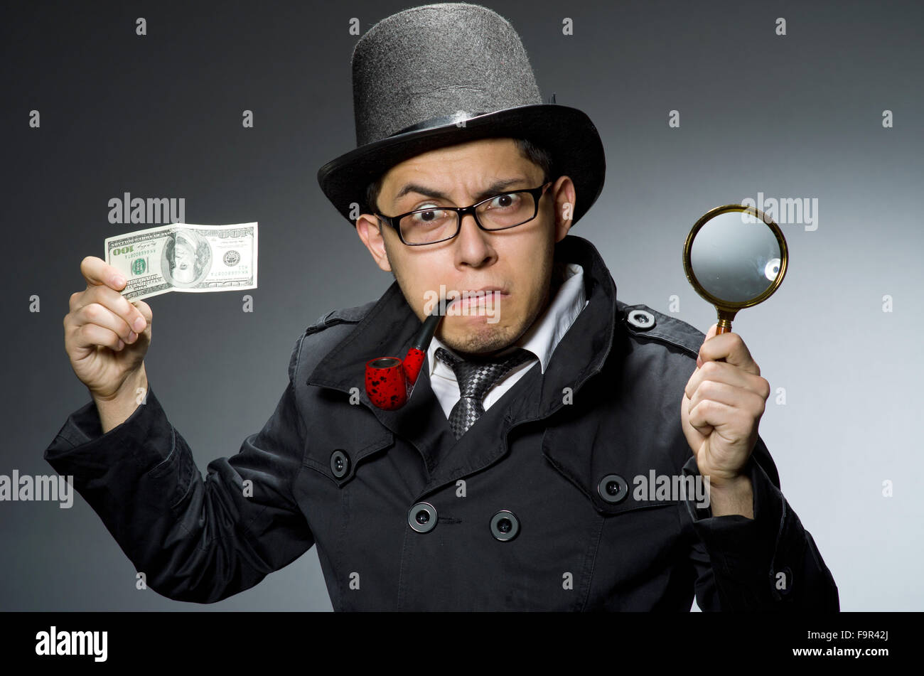 Young detective in black coat with money against gray Stock Photo - Alamy