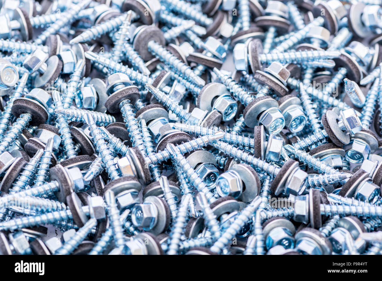 Many screws arranged as background Stock Photo - Alamy