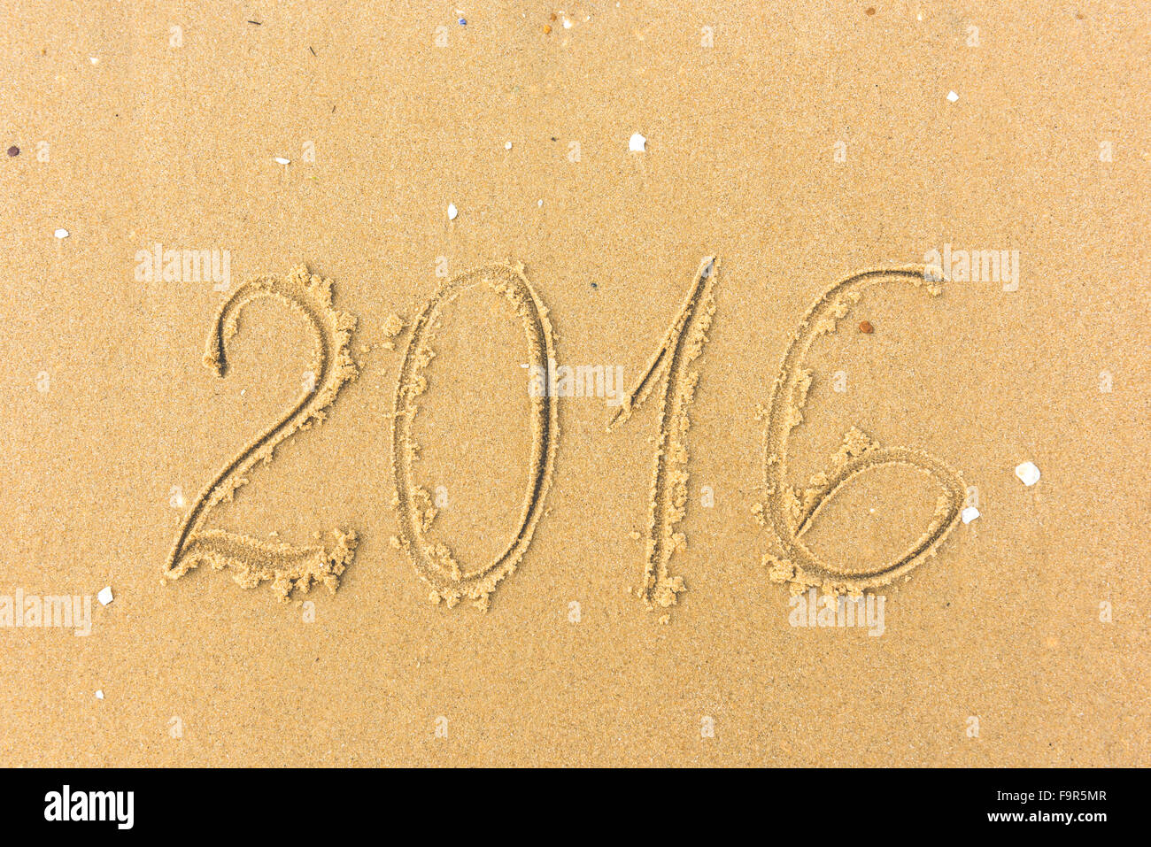 2016 Year written on the beach. sand background Stock Photo - Alamy