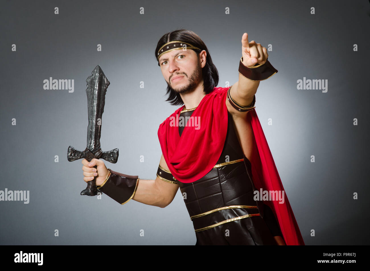 Roman warrior with sword against background Stock Photo - Alamy
