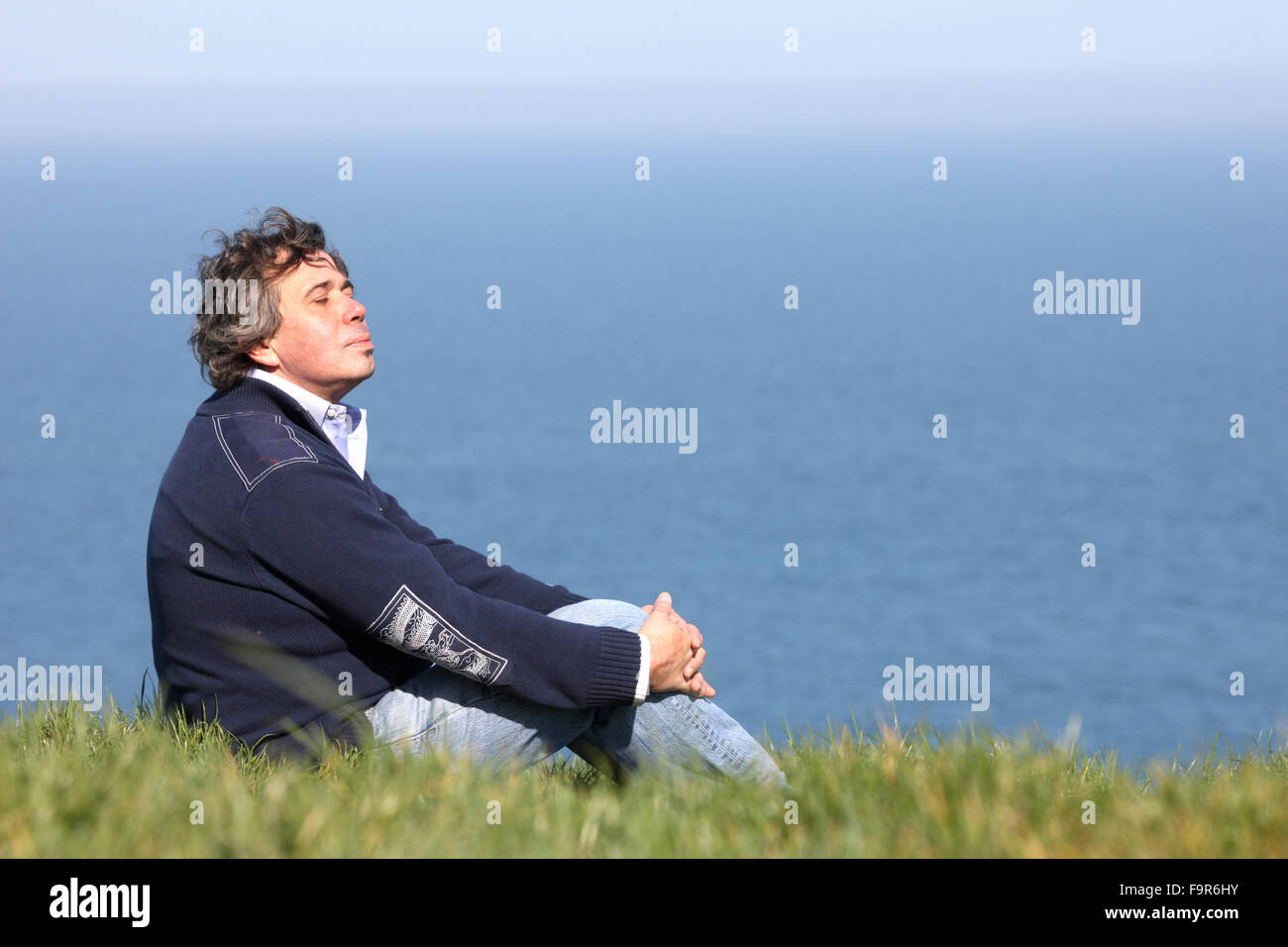 Praying at seaside Stock Photo - Alamy