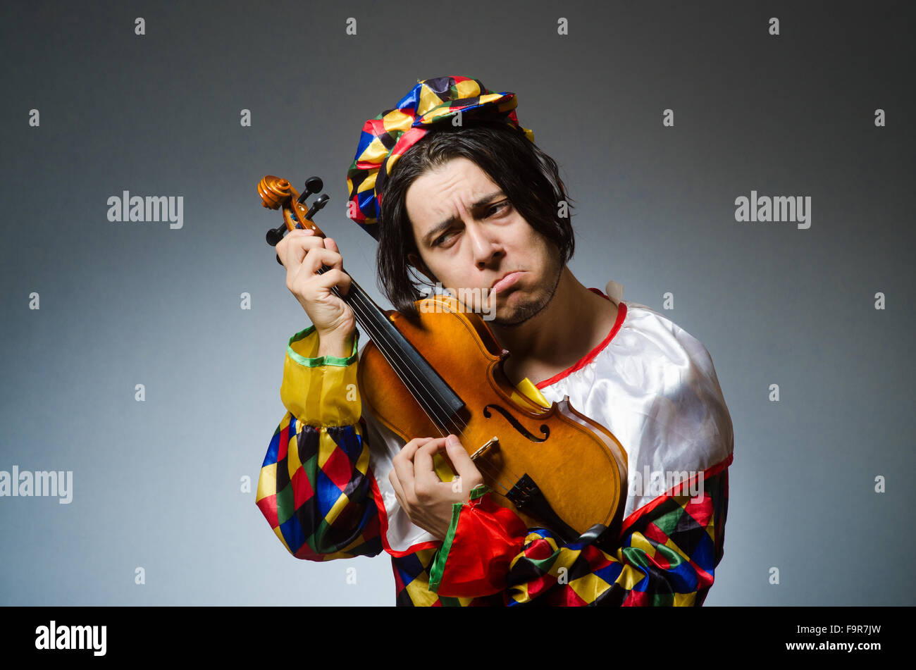 Funny violin clown player in musical concept Stock Photo - Alamy