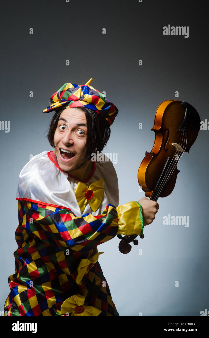Funny violin clown player in musical concept Stock Photo - Alamy