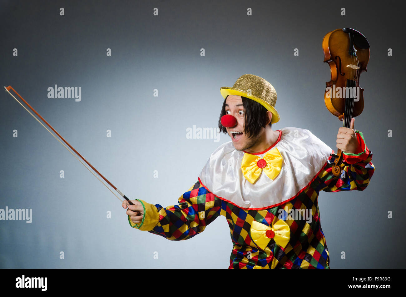 Funny violin clown player in musical concept Stock Photo - Alamy