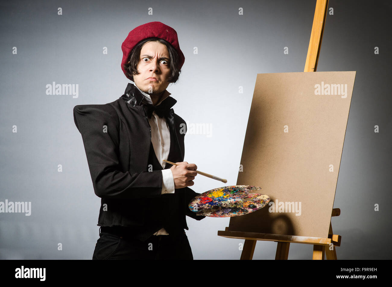 Funny artist in dark studio Stock Photo - Alamy