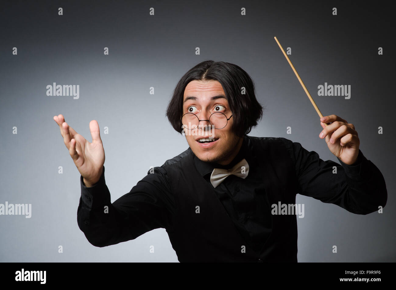 Funny conductor in musical concept Stock Photo - Alamy