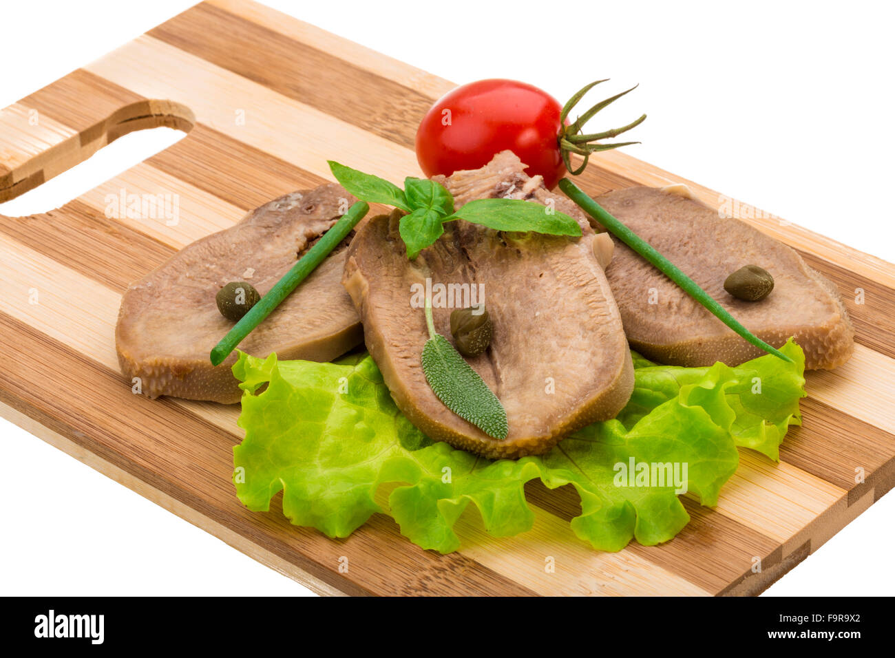 Beef tongue with herbs isolated Stock Photo - Alamy
