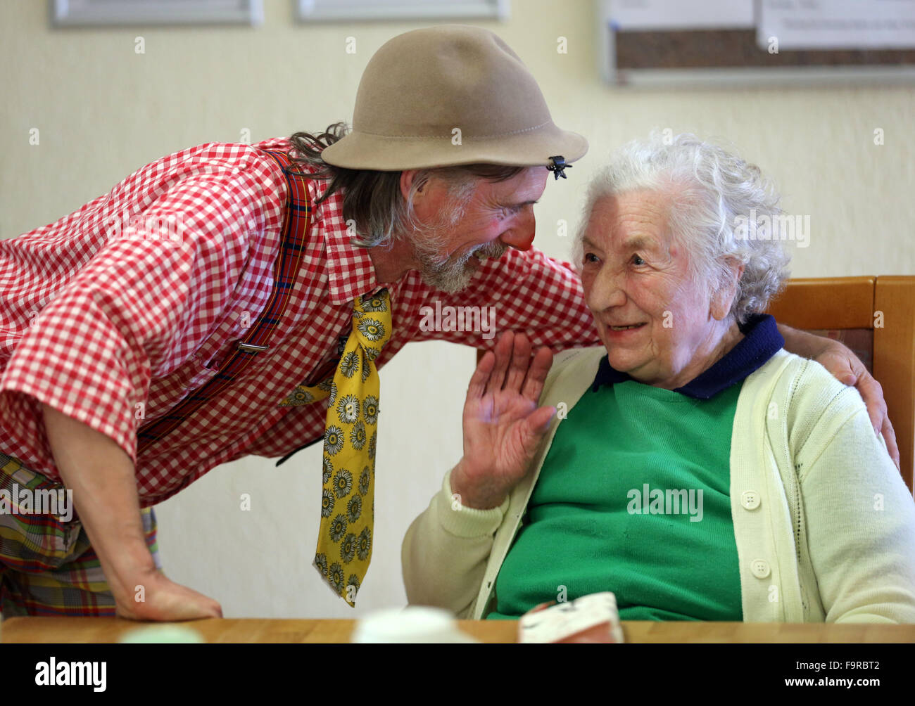 A music clown sings with old people with dementia in a hospital in ...