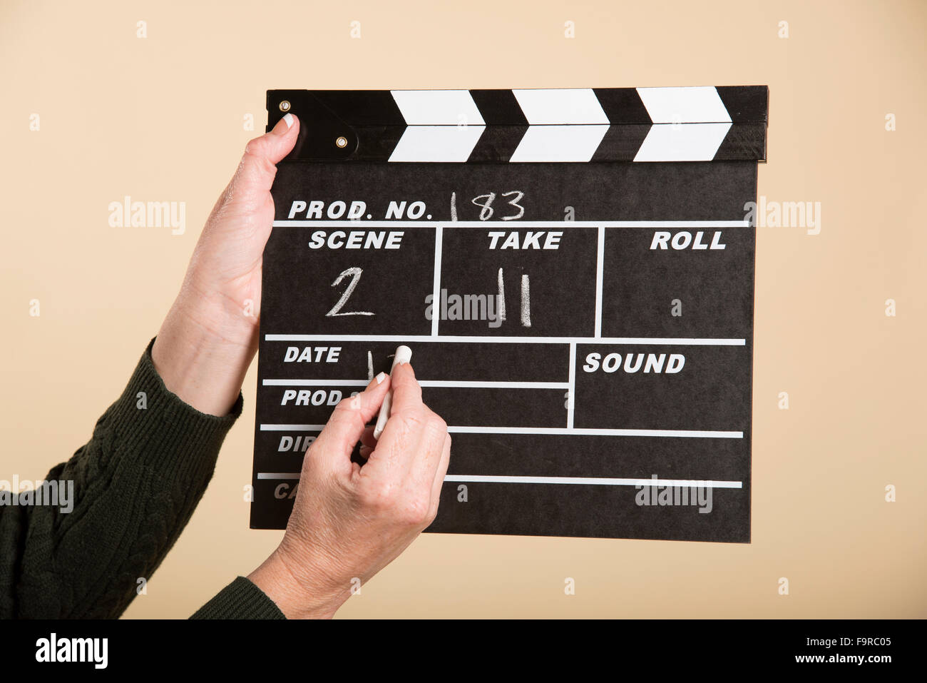 Woman holding a film production clapper board Stock Photo - Alamy