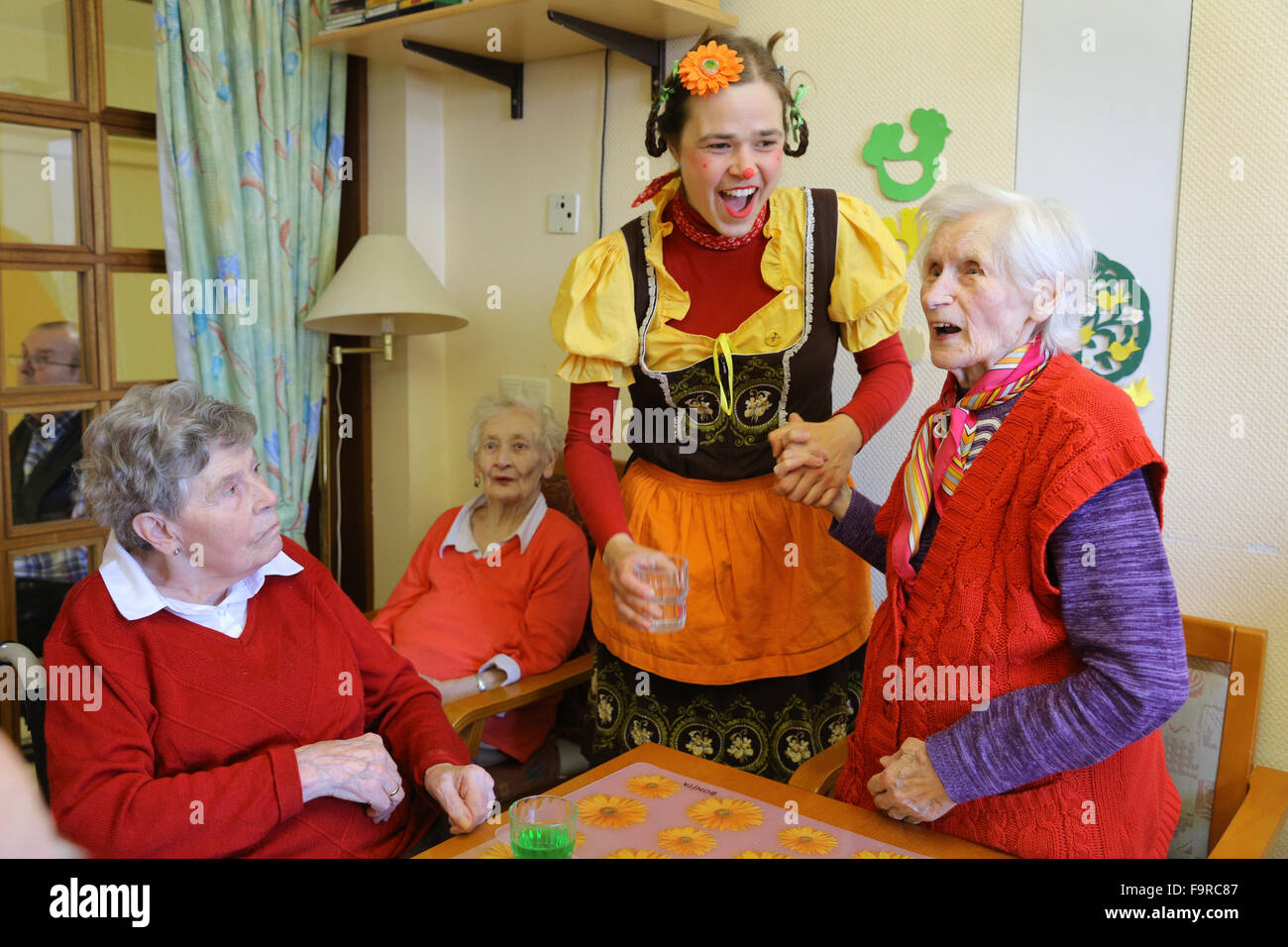 A music clown sings with old people with dementia in a hospital in ...